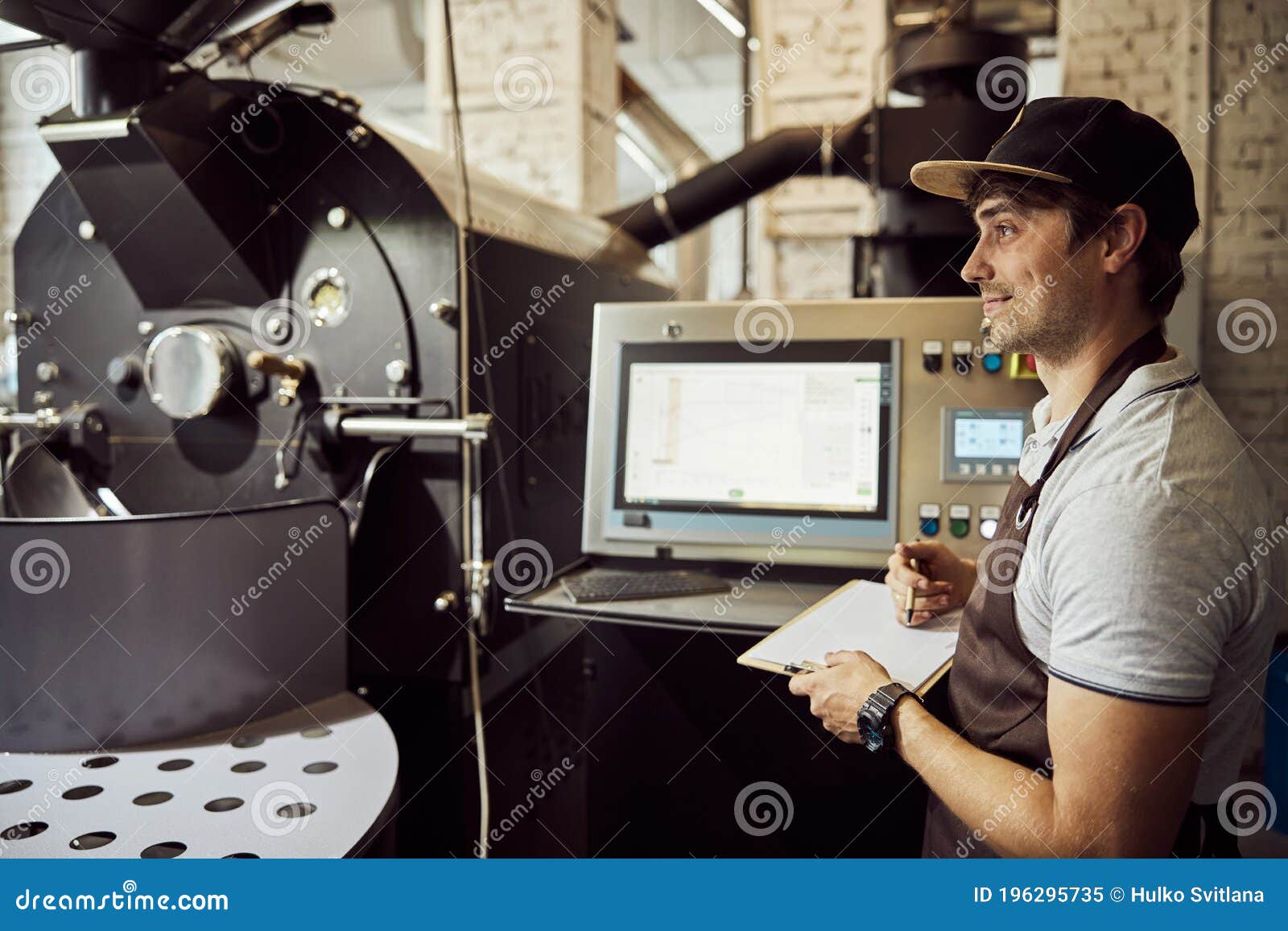 Handsome Male Worker Using Coffee Roasting Machine and Taking Notes ...