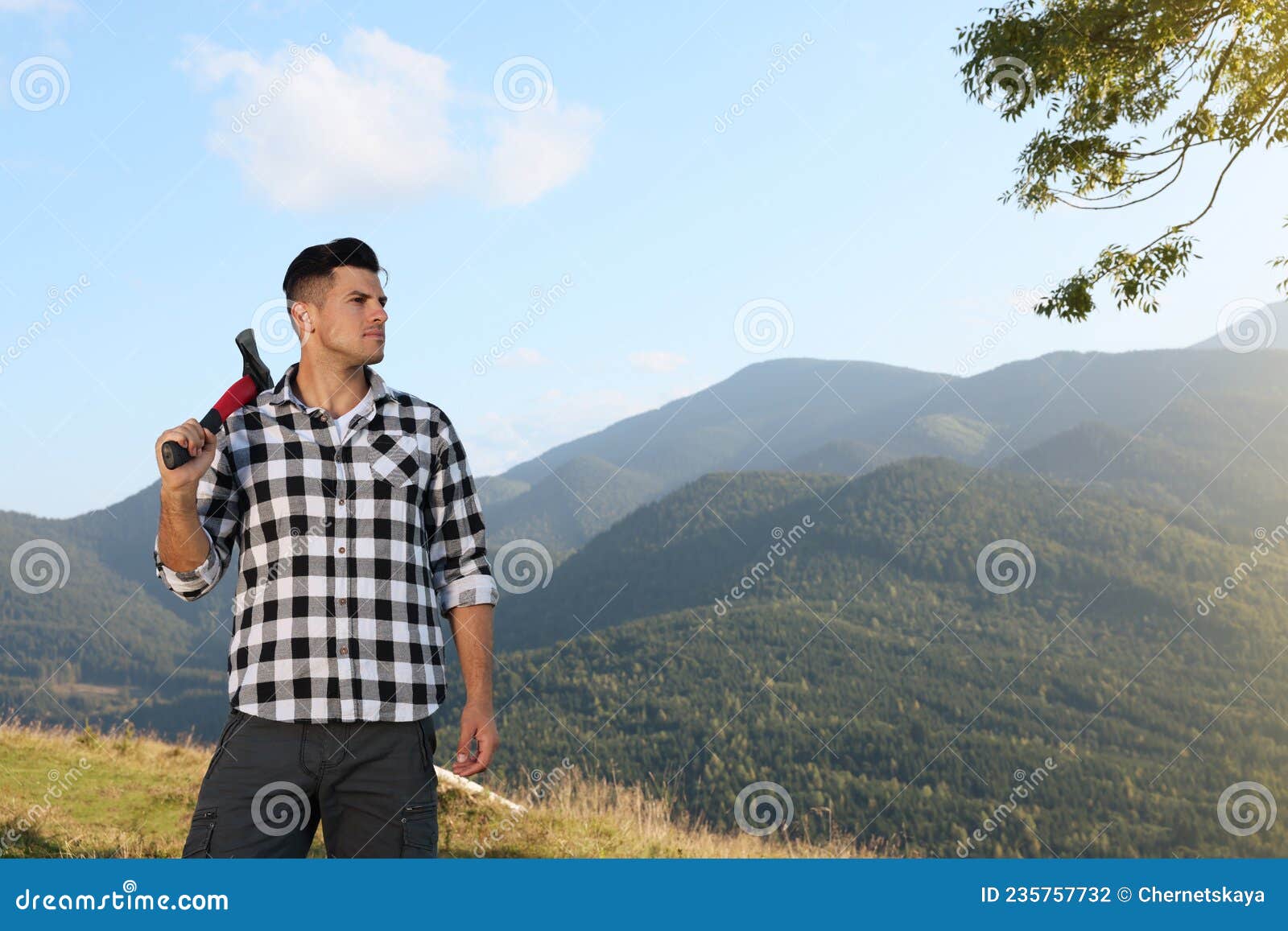 Handsome Man with Axe in Mountains, Space for Text Stock Photo - Image ...