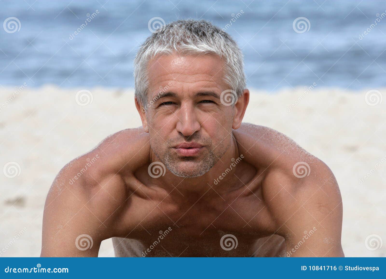 Handsome man on the beach stock photo. Image of natural - 10841716