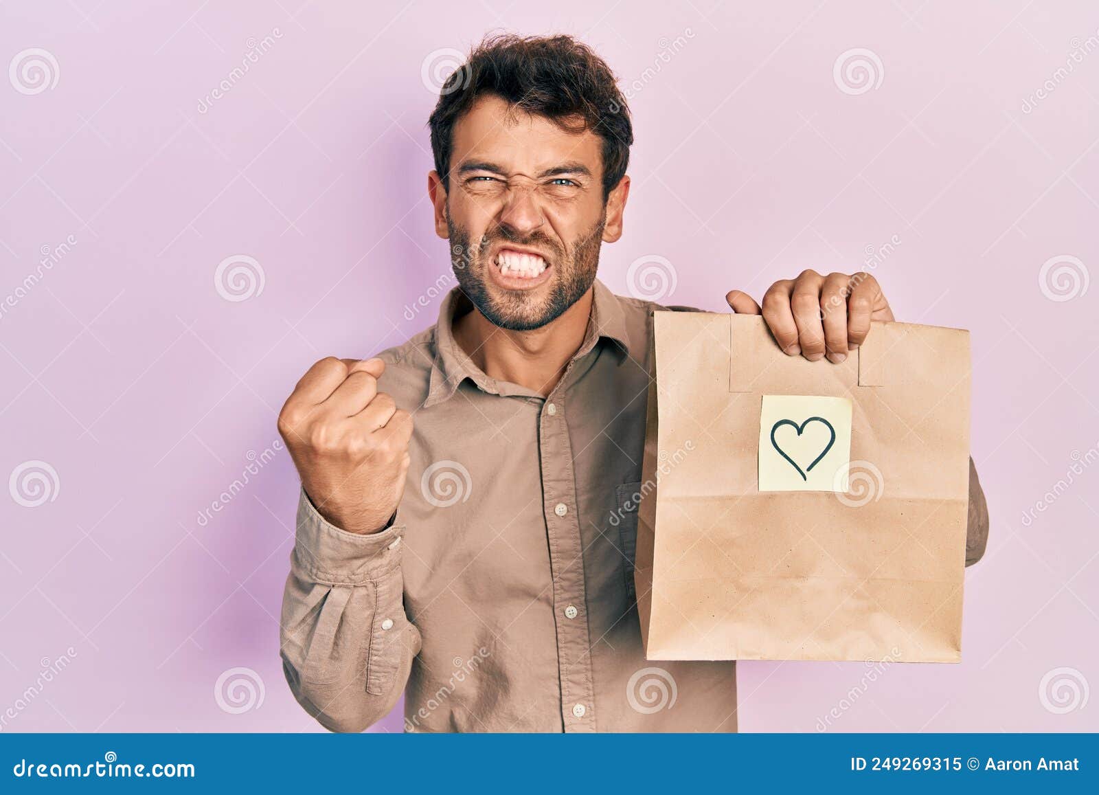 Handsome Man With Beard Holding Delivery Paper Bag With Heart Reminder