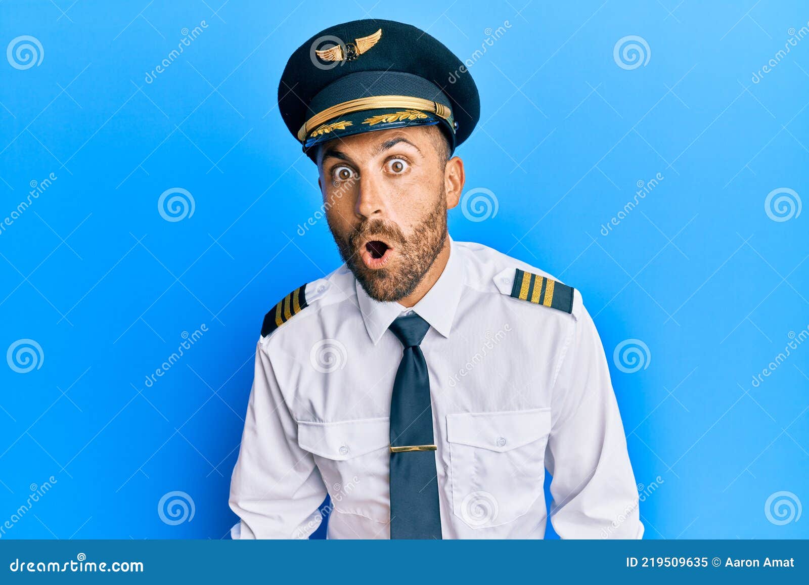 Handsome Man With Beard Wearing Airplane Pilot Uniform Afraid And