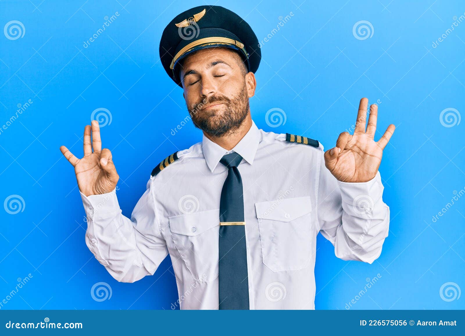 Handsome Man With Beard Wearing Airplane Pilot Uniform Relax And