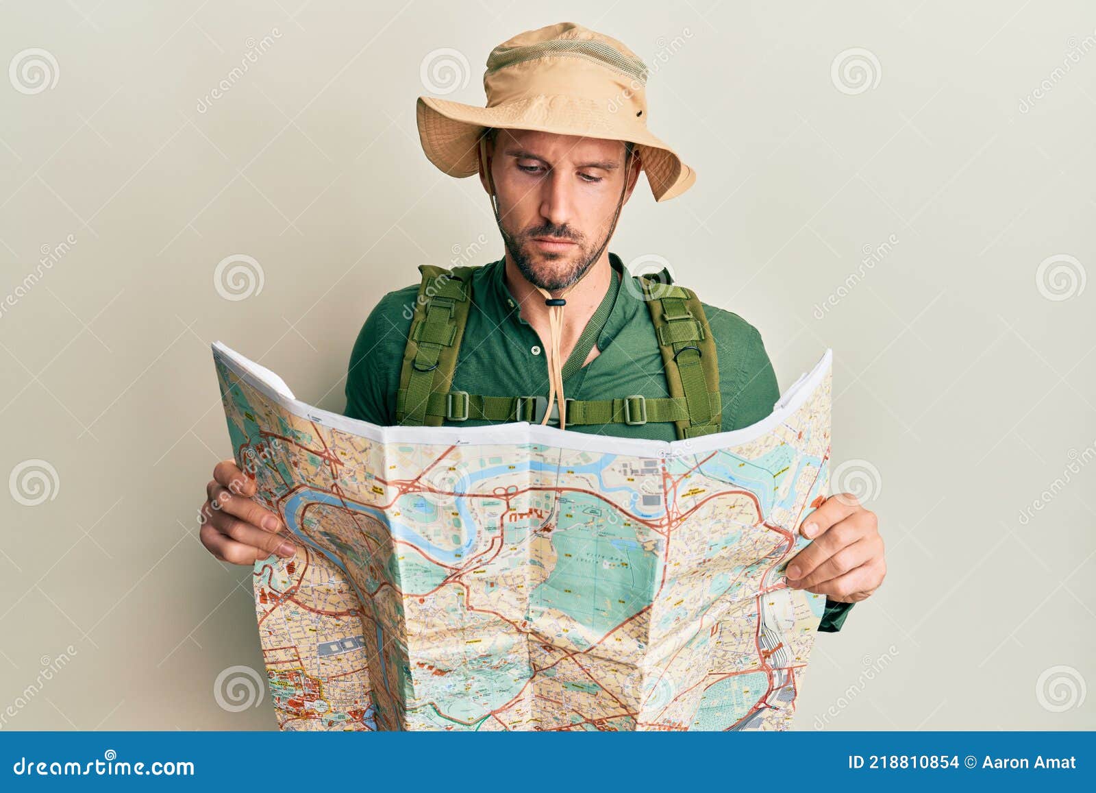 Handsome Man with Beard Wearing Explorer Hat Holding Map Relaxed with ...