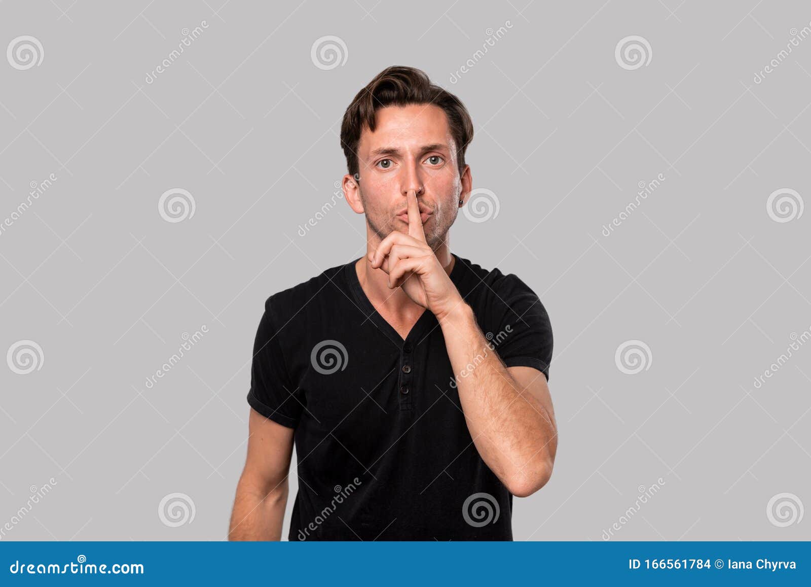 Handsome Man in a Black Tee Showing with a Finger Gesture To Keep ...
