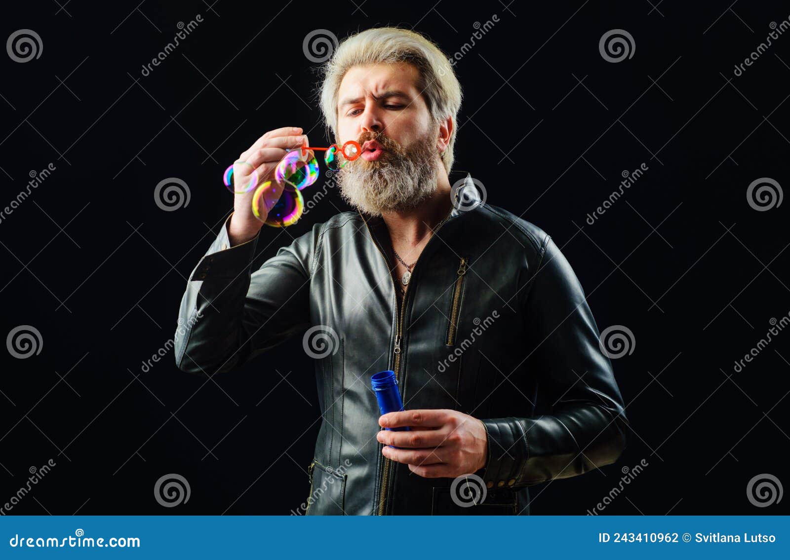 Handsome Man Blowing Bubbles. Play with Soap Bubble. Bearded Guy in ...