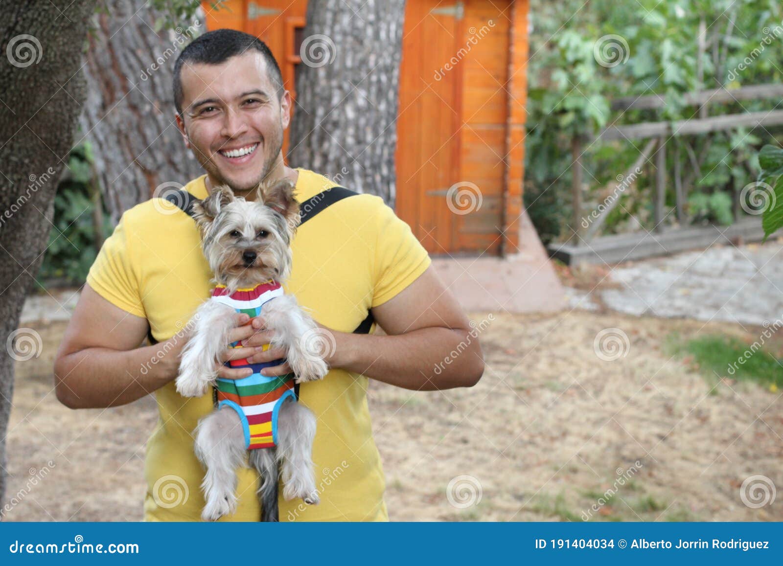 Handsome Man Carrying Dog in Striped Backpack Stock Photo - Image of ...