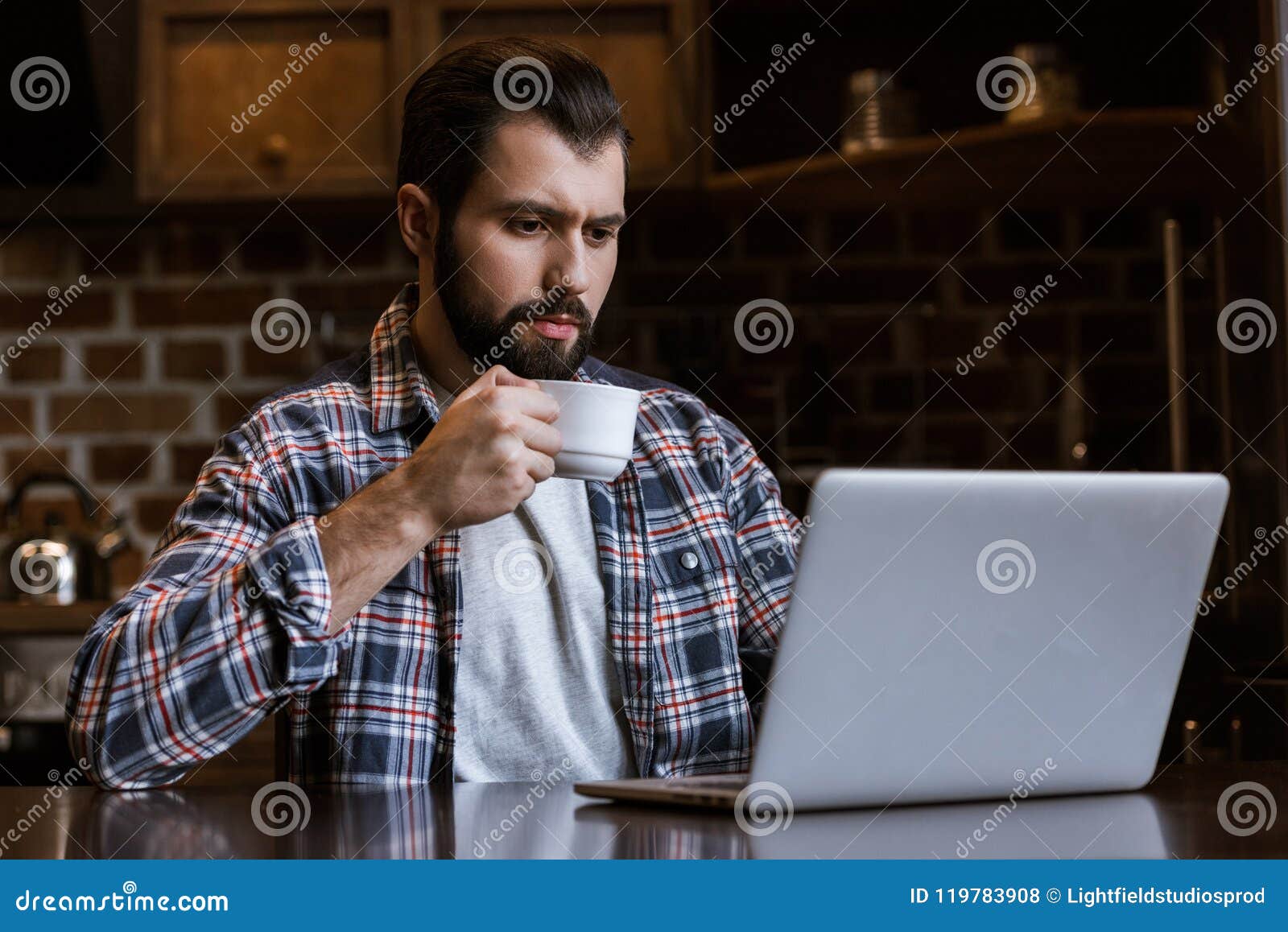 Handsome Man with Coffee Cup Sitting at Table Stock Photo - Image of ...
