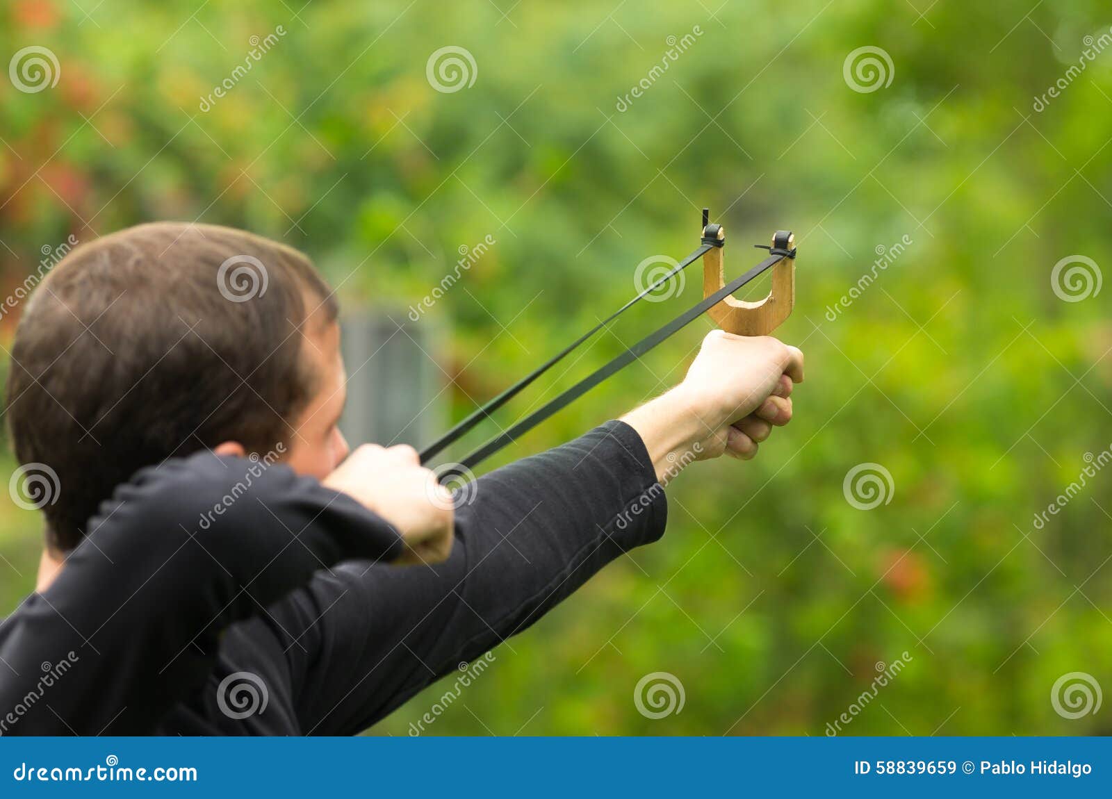 Handsome Man Concentrated Aiming a Slingshot at Stock Image - Image of ...