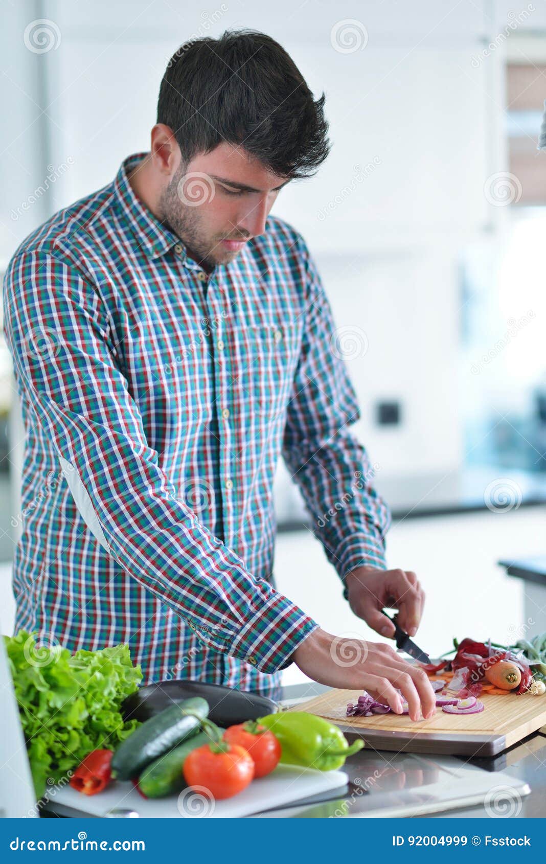 Handsome Man Cooking at Home Preparing Salad in Kitchen. Stock Image ...
