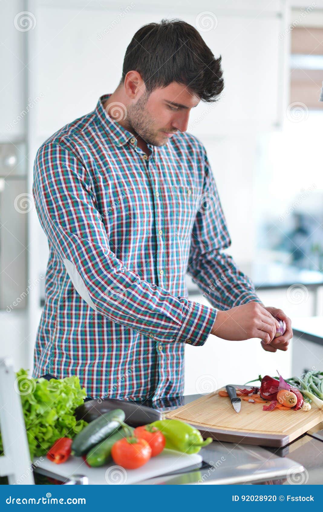 Handsome Man Cooking at Home Preparing Salad in Kitchen. Stock Photo ...