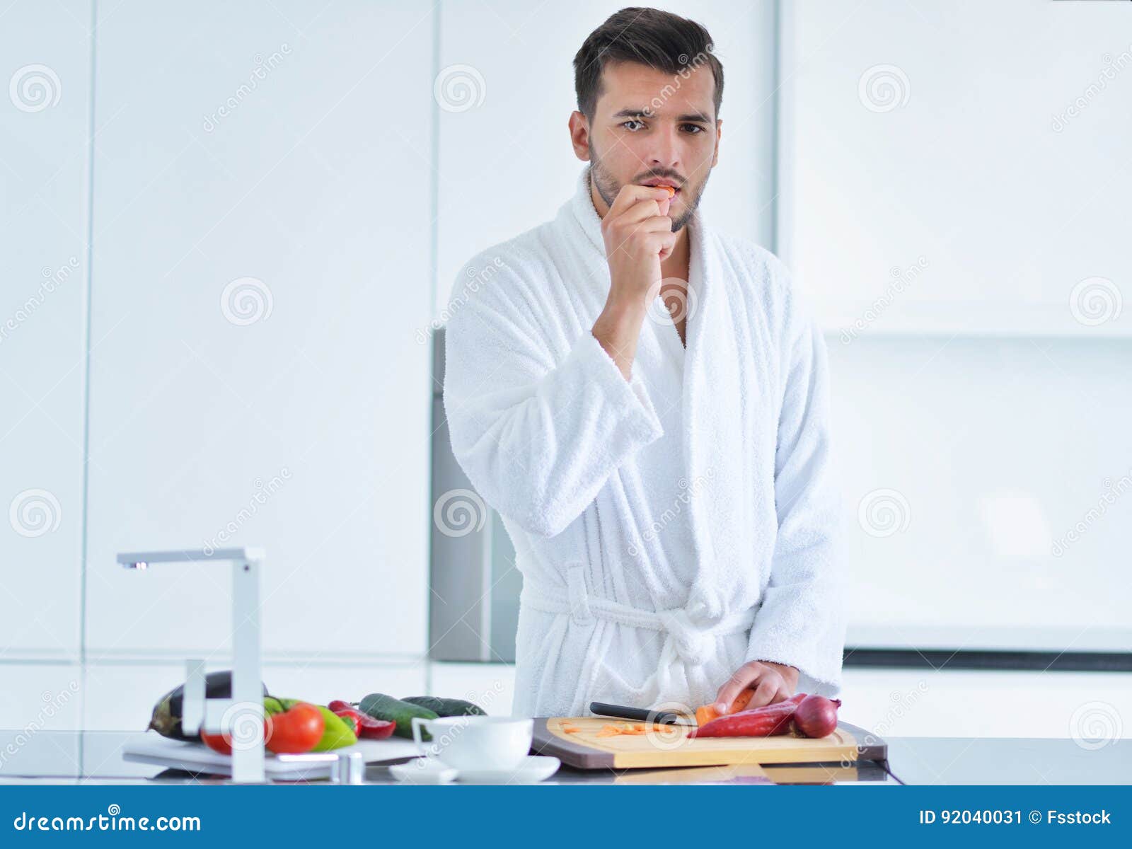 Handsome Man Cooking at Home Preparing Salad in Kitchen. Stock Image ...