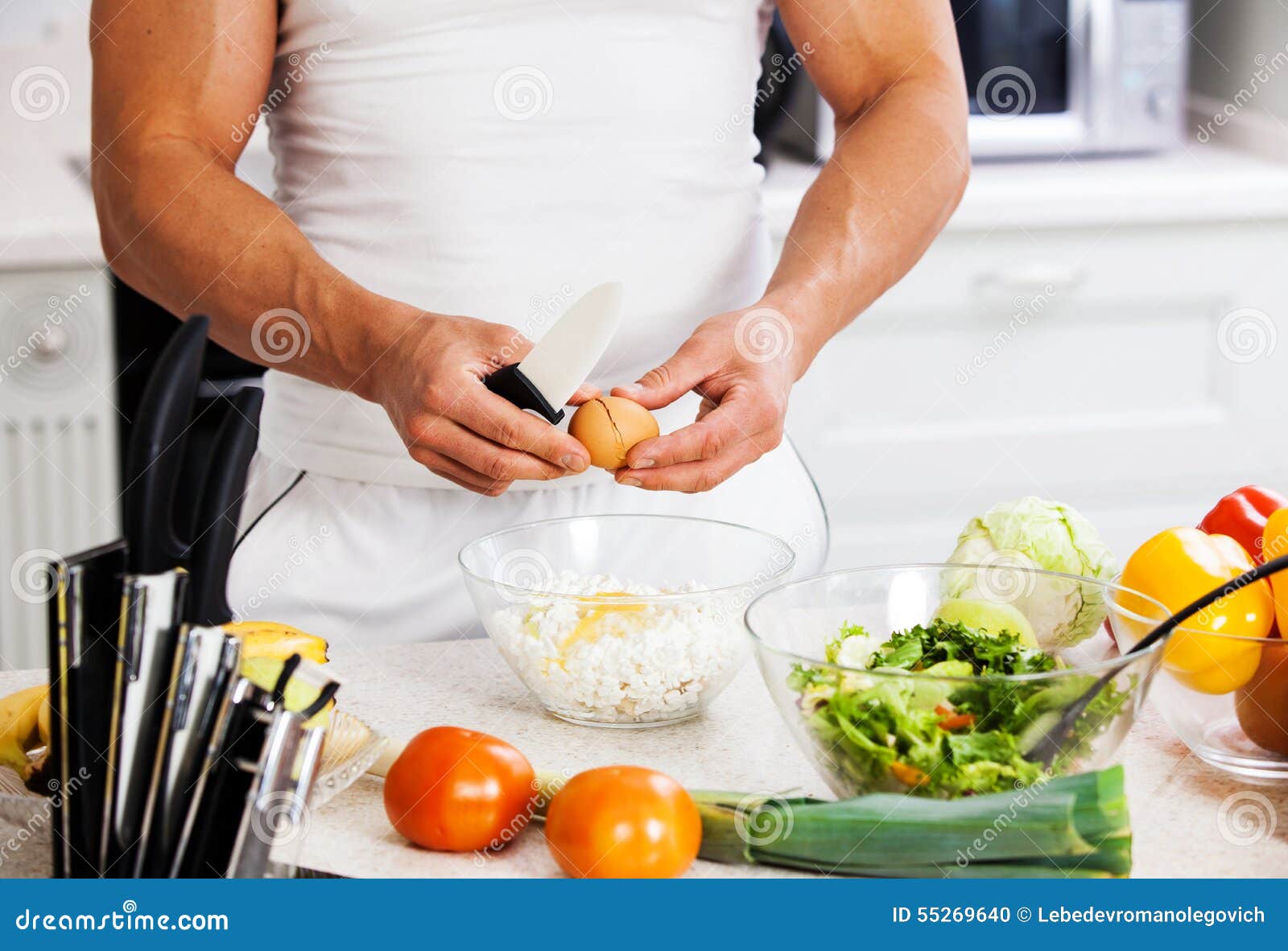 Handsome Man Cooking at Home Preparing Salad in Kitchen. Stock Photo ...