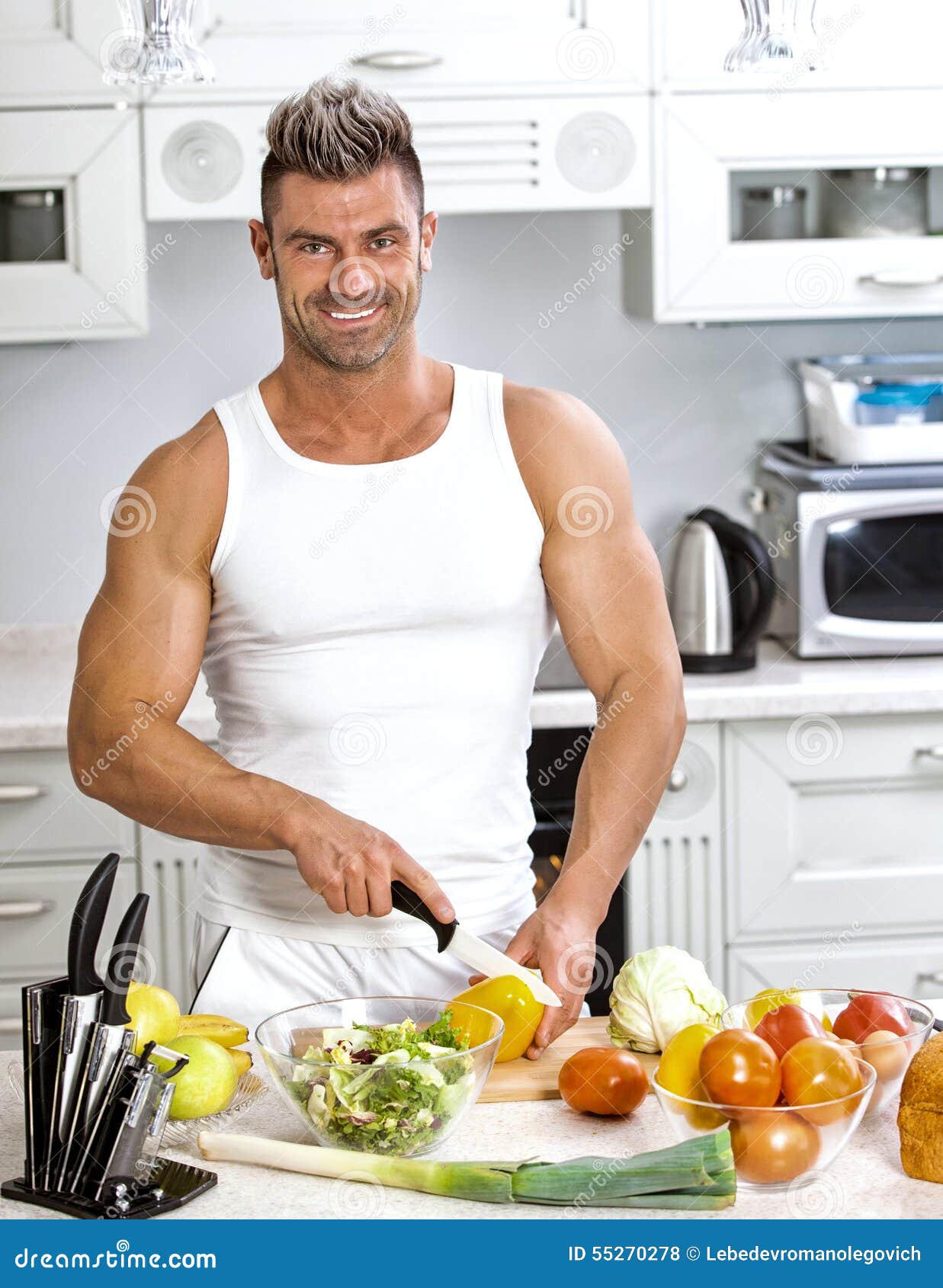 Handsome Man Cooking at Home Preparing Salad in Kitchen. Stock Photo ...