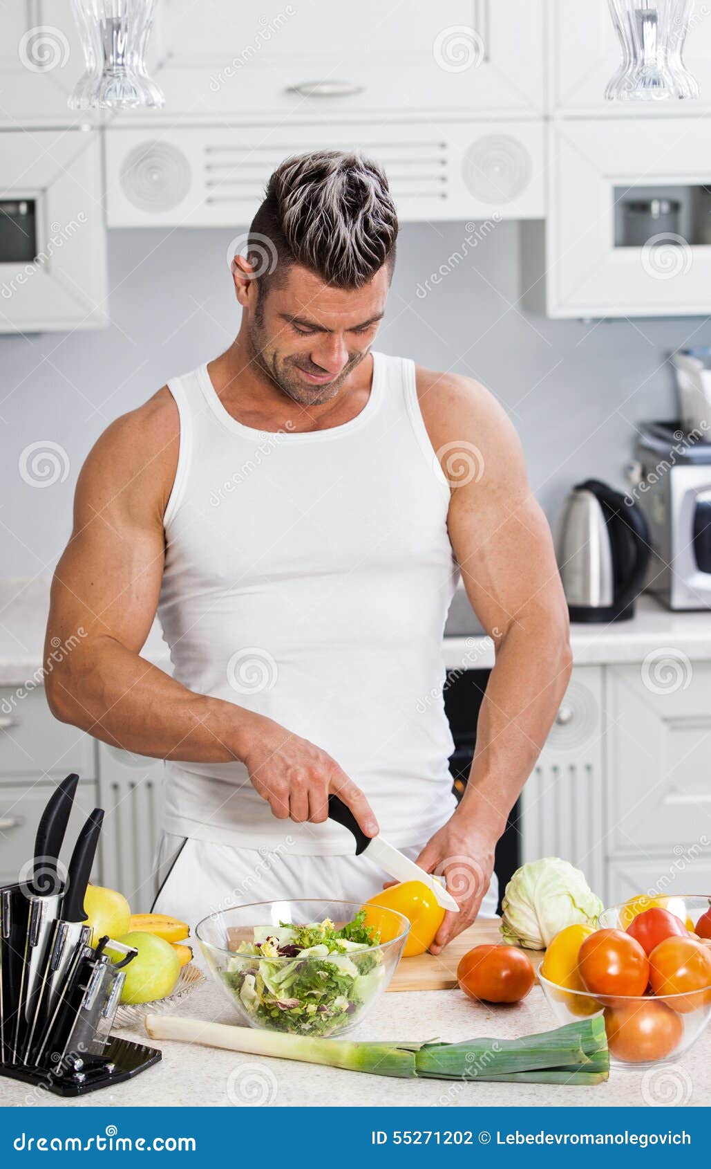 Handsome Man Cooking at Home Preparing Salad in Kitchen. Stock Photo ...