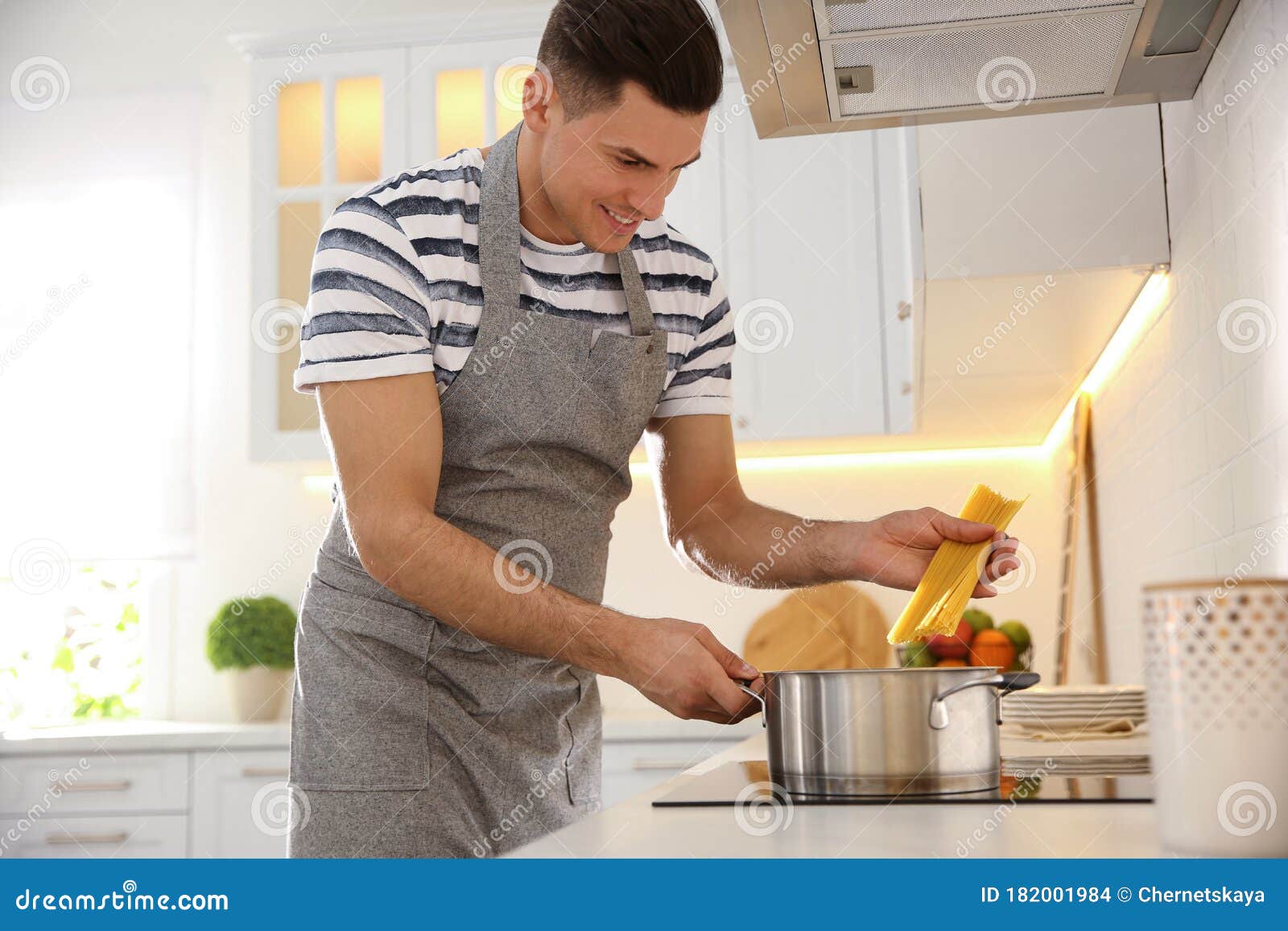 Handsome Man Cooking Pasta on Stove Stock Photo - Image of male, diet ...