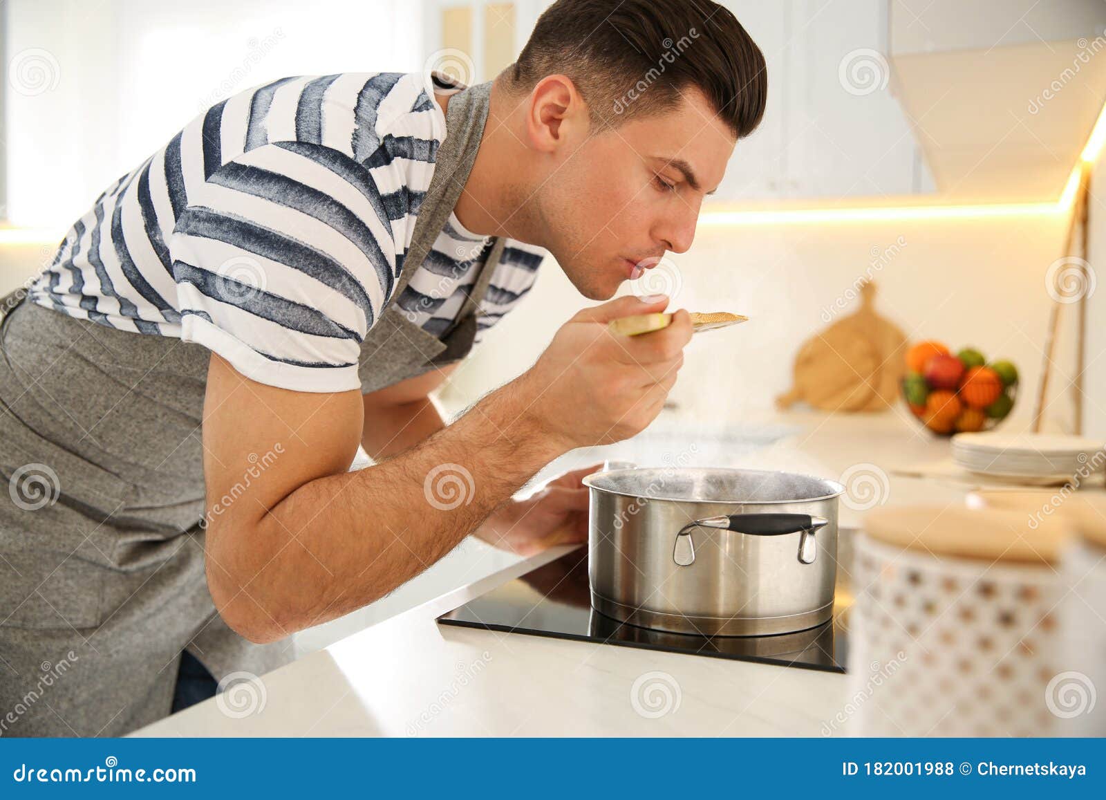 Handsome Man Cooking on Stove Stock Photo - Image of cooktop, cuisine ...