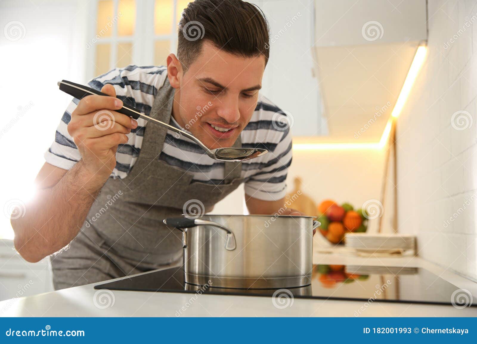 Handsome Man Cooking on Stove Stock Image - Image of apron, culinary ...