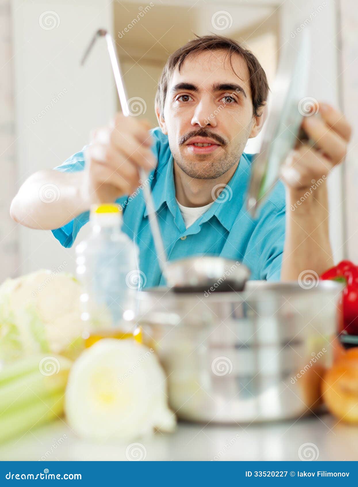 Handsome man cooks lunch stock image. Image of caucasian - 33520227