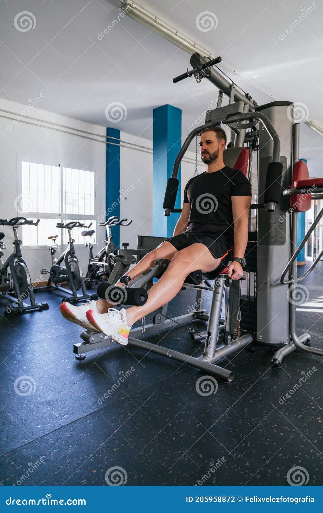 Handsome Man Doing Leg Exercises in a Gym. Vertical Stock Photo - Image ...