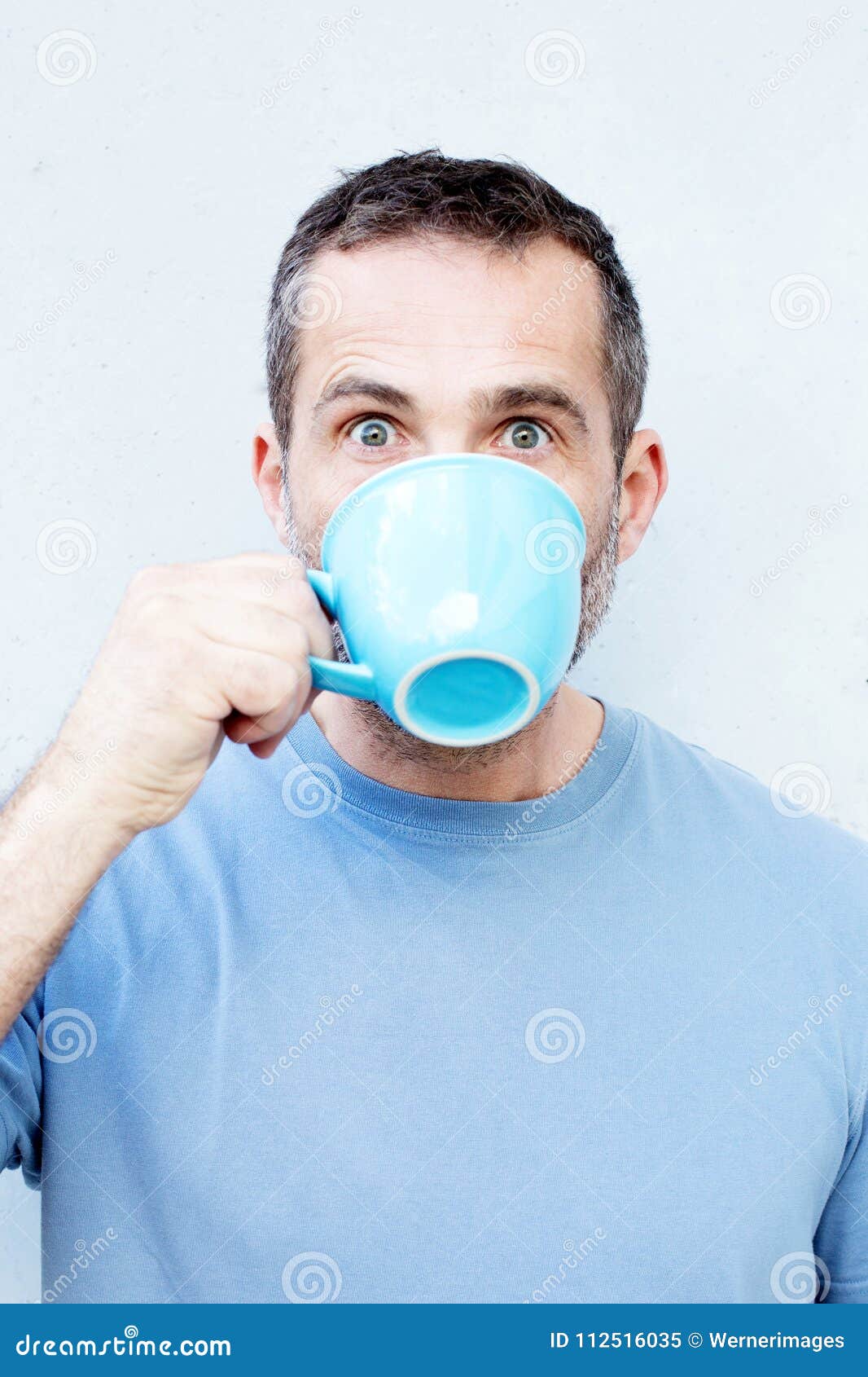 Handsome Man Drinking from Blue Cup Stock Image - Image of handsome ...