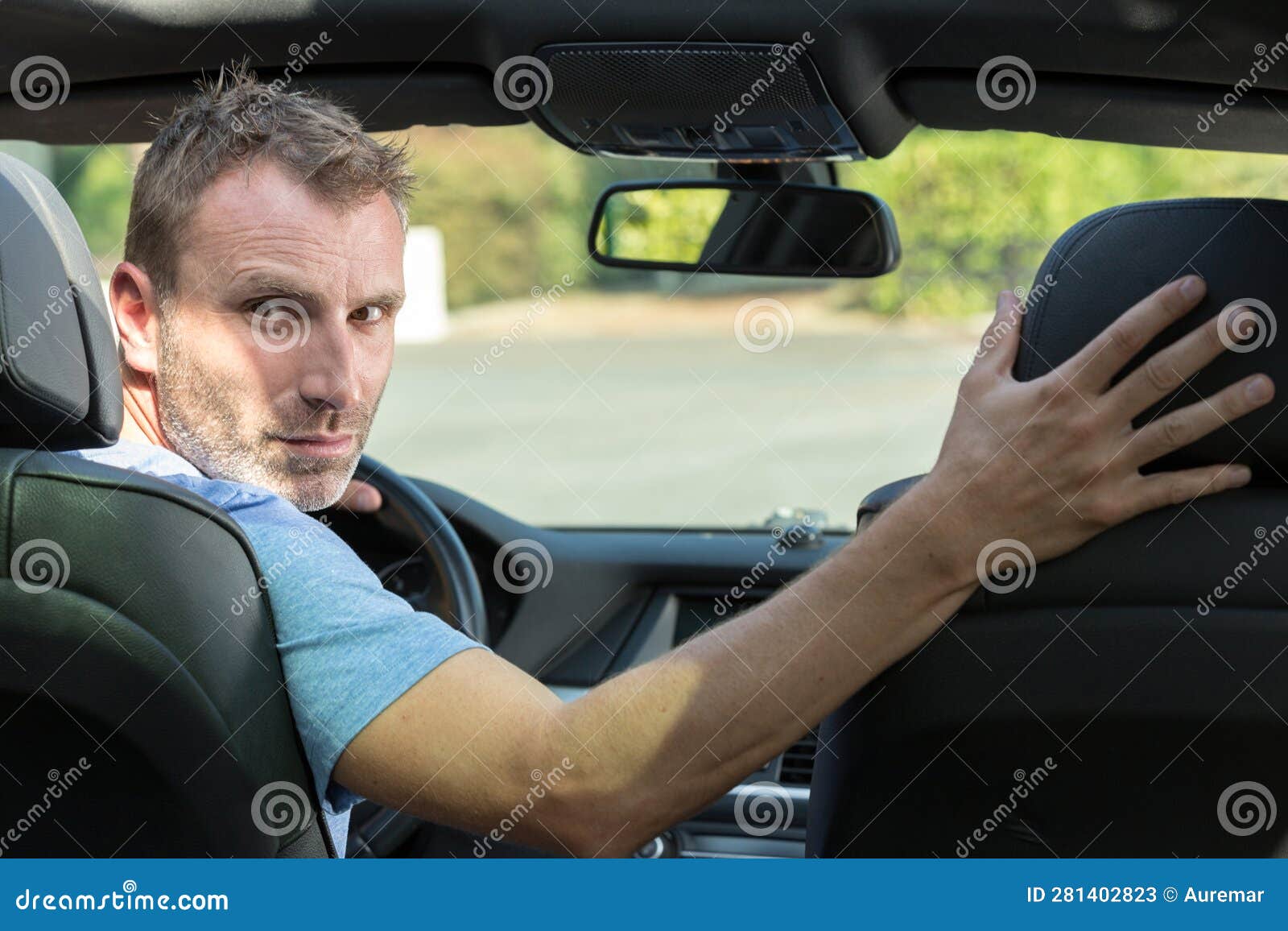Handsome Man Driving in Reverse Stock Image - Image of serious, wheel ...