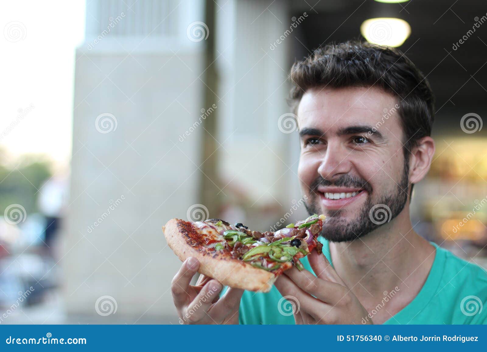 Handsome man eating pizza stock photo. Image of male - 51756340