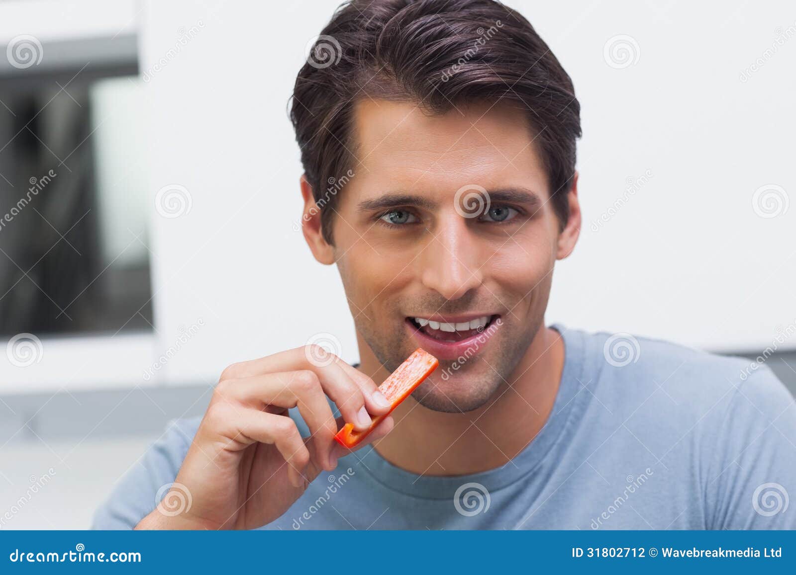 Handsome Man Eating a Slice of Bell Pepper Stock Photo - Image of ...
