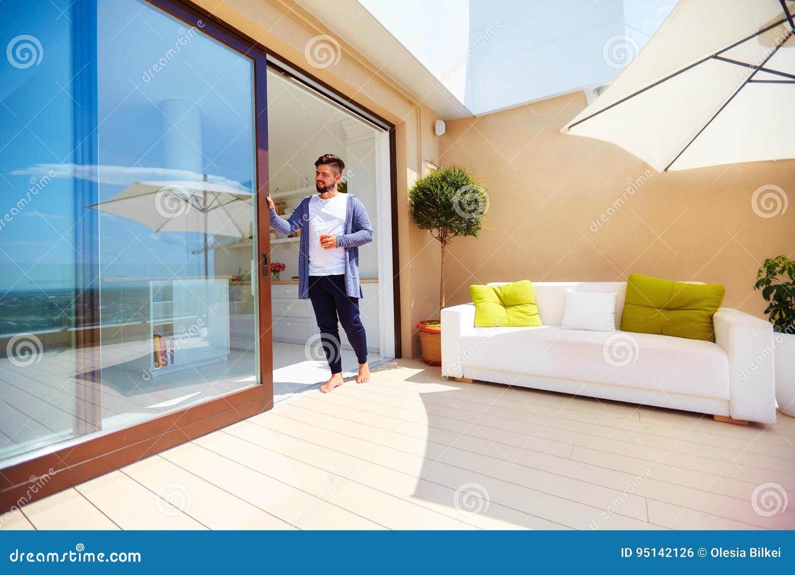 Handsome Man Enjoys Life on Rooftop Terrace, with Open Space Kitchen ...