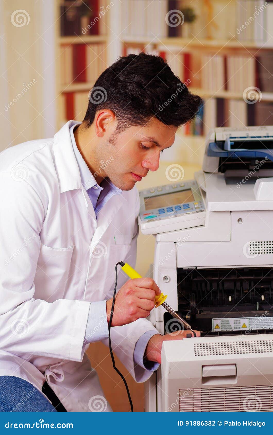 Handsome Man Fixing a Photocopier during Maintenance Using a ...