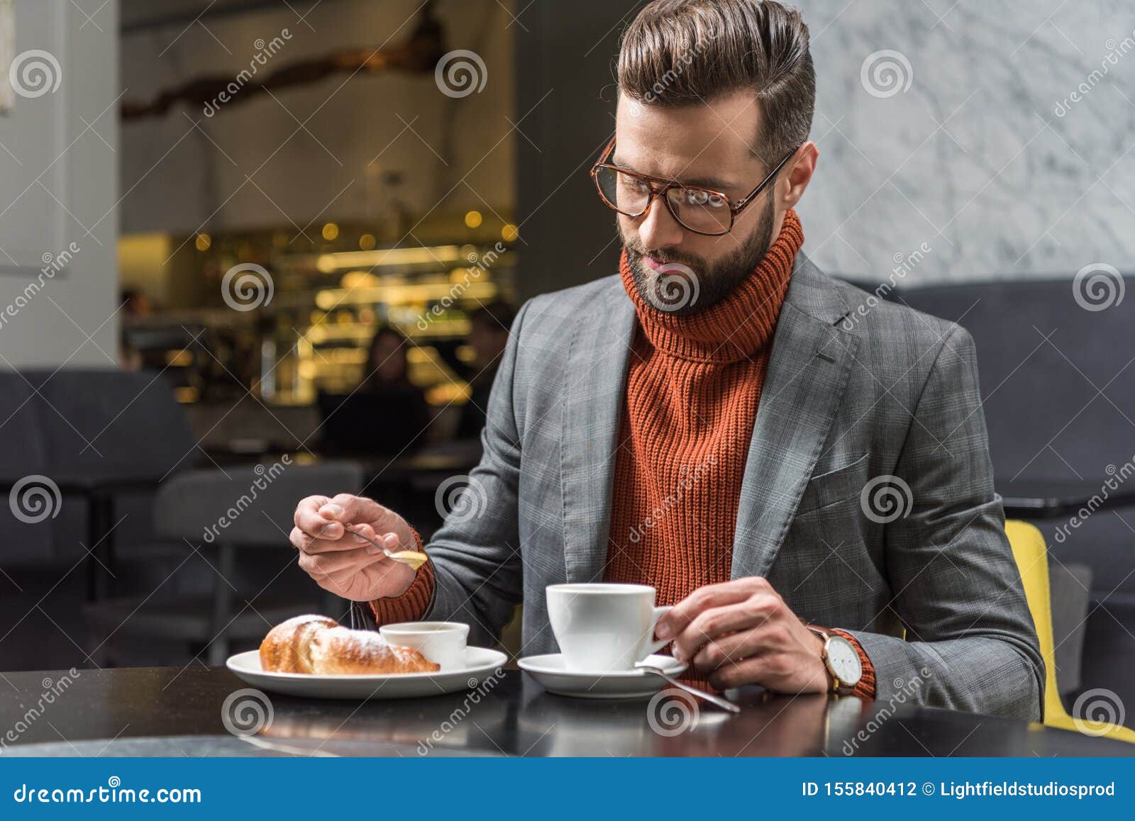 Handsome Man In Formal Wear And Glasses Sitting At Table During Lunch
