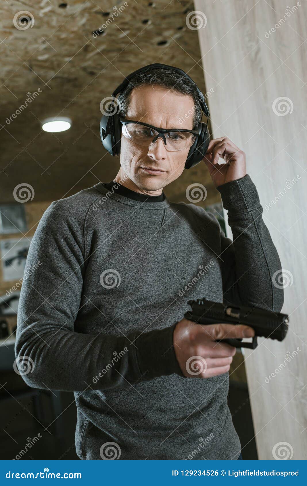 Handsome man with gun stock photo. Image of weapon, male - 129234526