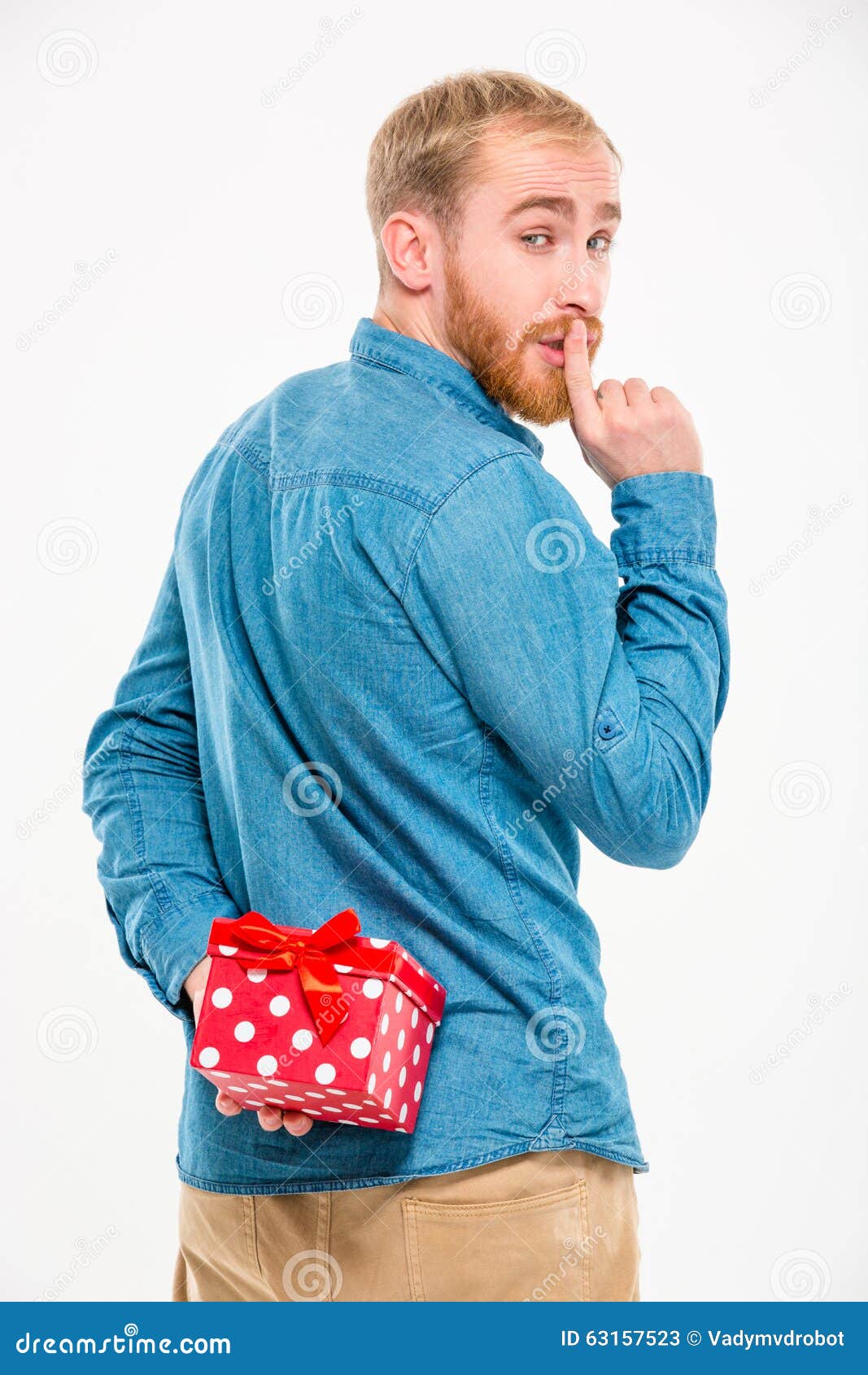 Handsome Man Hiding Gift Behind Back and Gesturing Silence Stock Image ...