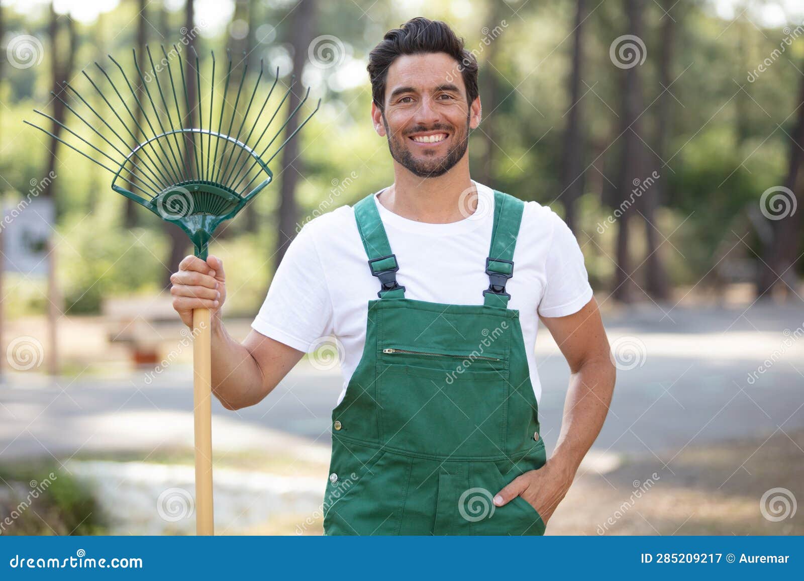 Handsome Man Holding Rake in Garden Stock Image - Image of casual ...