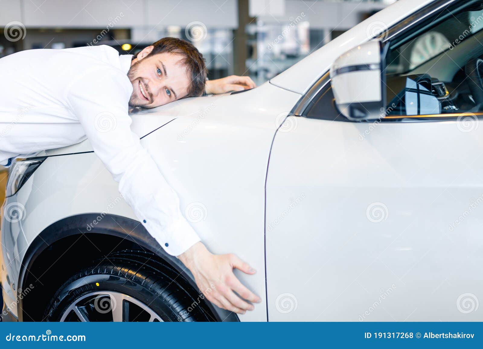 Handsome Man Hugging His New Car in Showroom Stock Photo - Image of ...