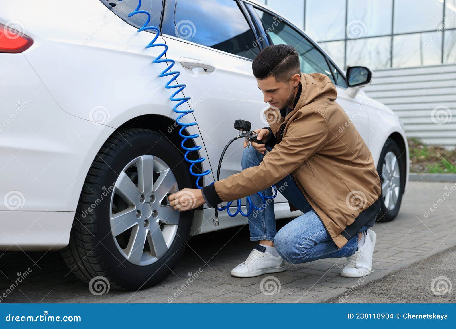 Handsome Man Inflating Tire at Car Service Stock Photo - Image of male ...