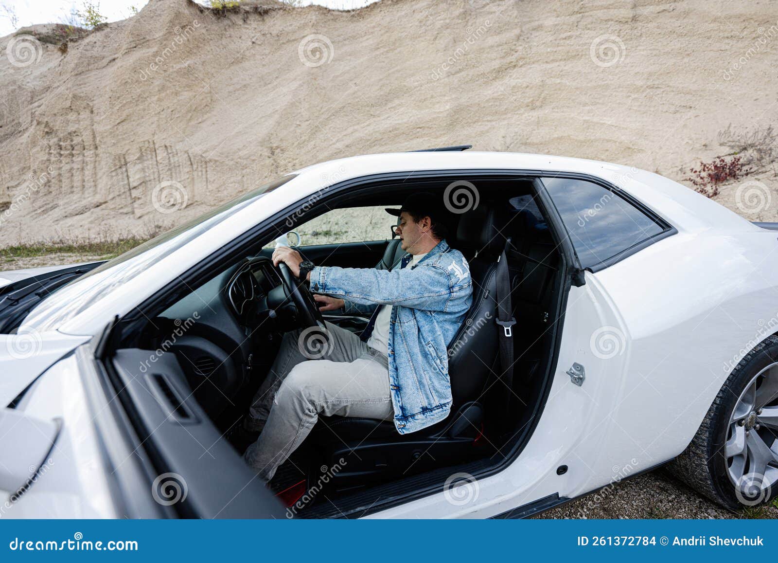 Handsome Man in Jeans Jacket and Cap Sit at His White Muscle Car Stock ...