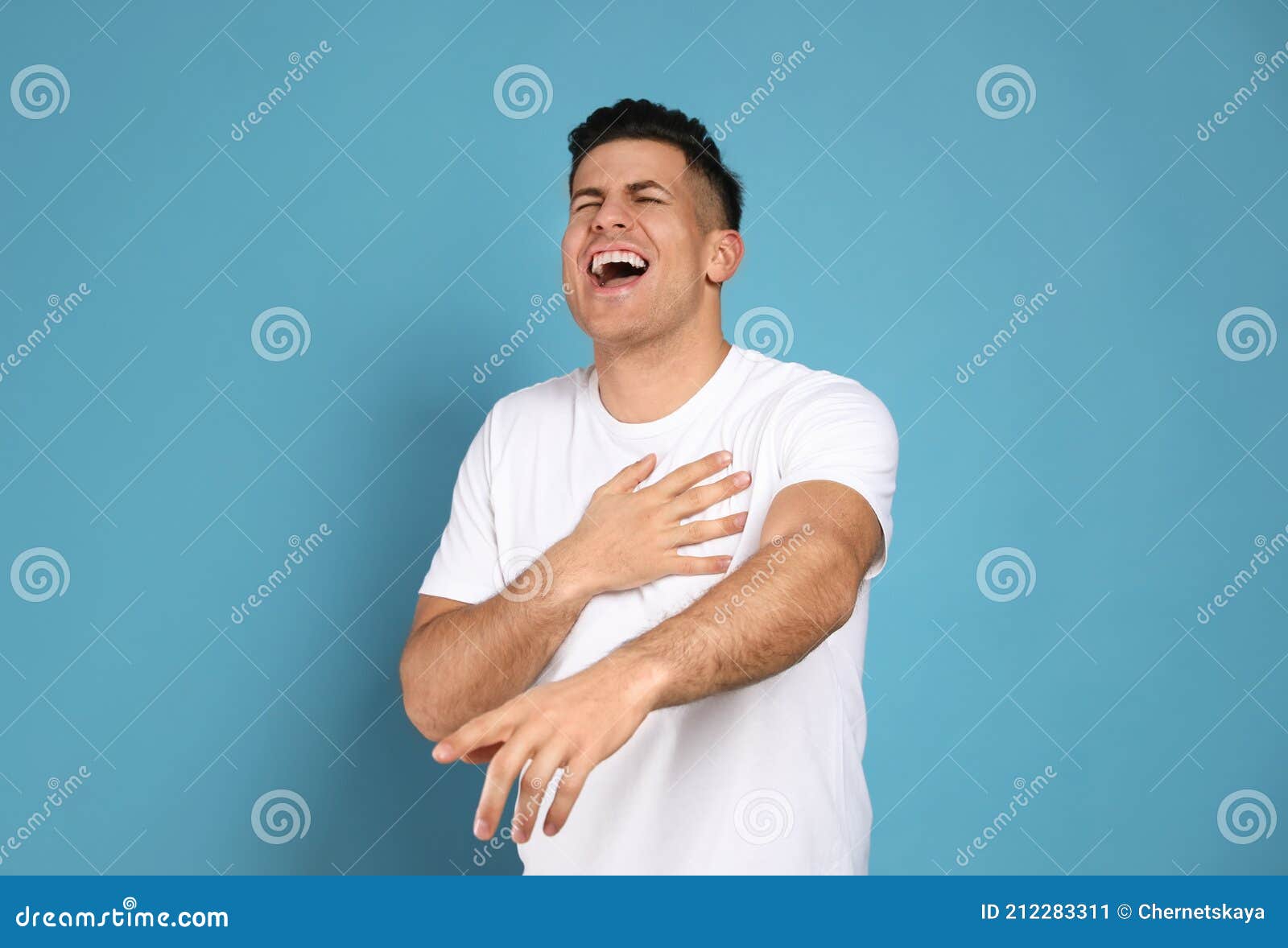 Handsome Man Laughing on Light Blue Background. Funny Joke Stock Image ...