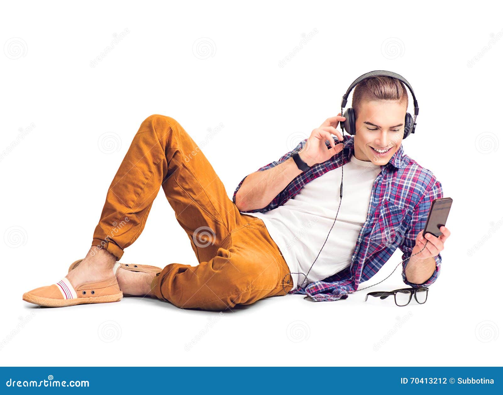 Handsome Man Listening To Music In Headphones With Smartphone Stock