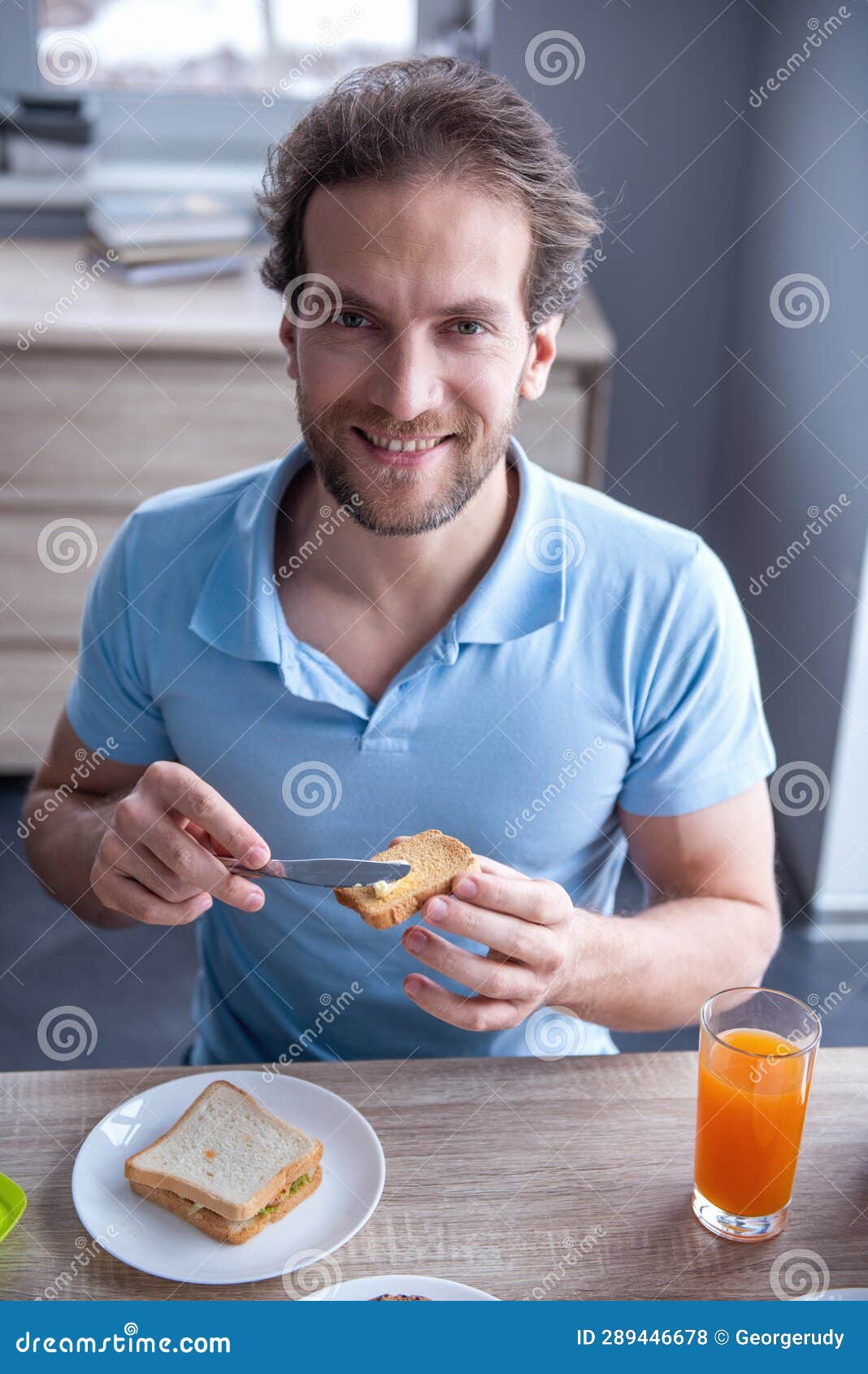 Handsome man eating stock photo. Image of home, juice - 289446678
