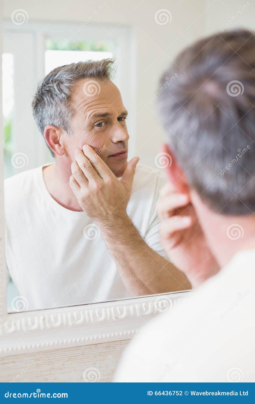 Handsome Man Looking at Himself in the Mirror Stock Photo - Image of ...