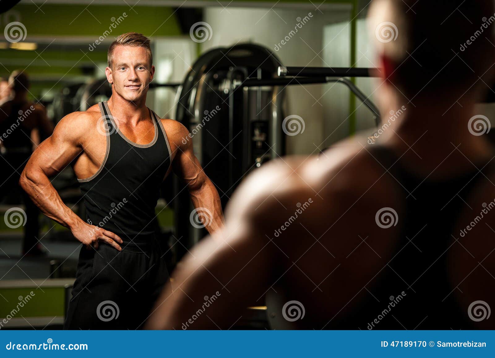 Handsome Man Looking in Mirror after Body Building Workout in Fitness ...