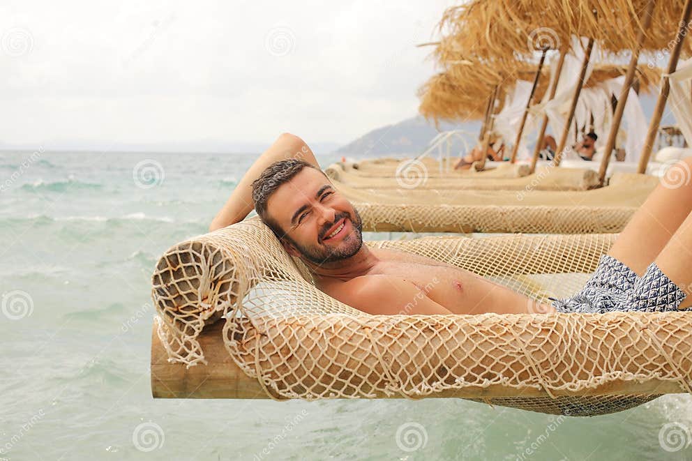 Handsome Man Lying Down on Suspended Net Stock Image - Image of ...