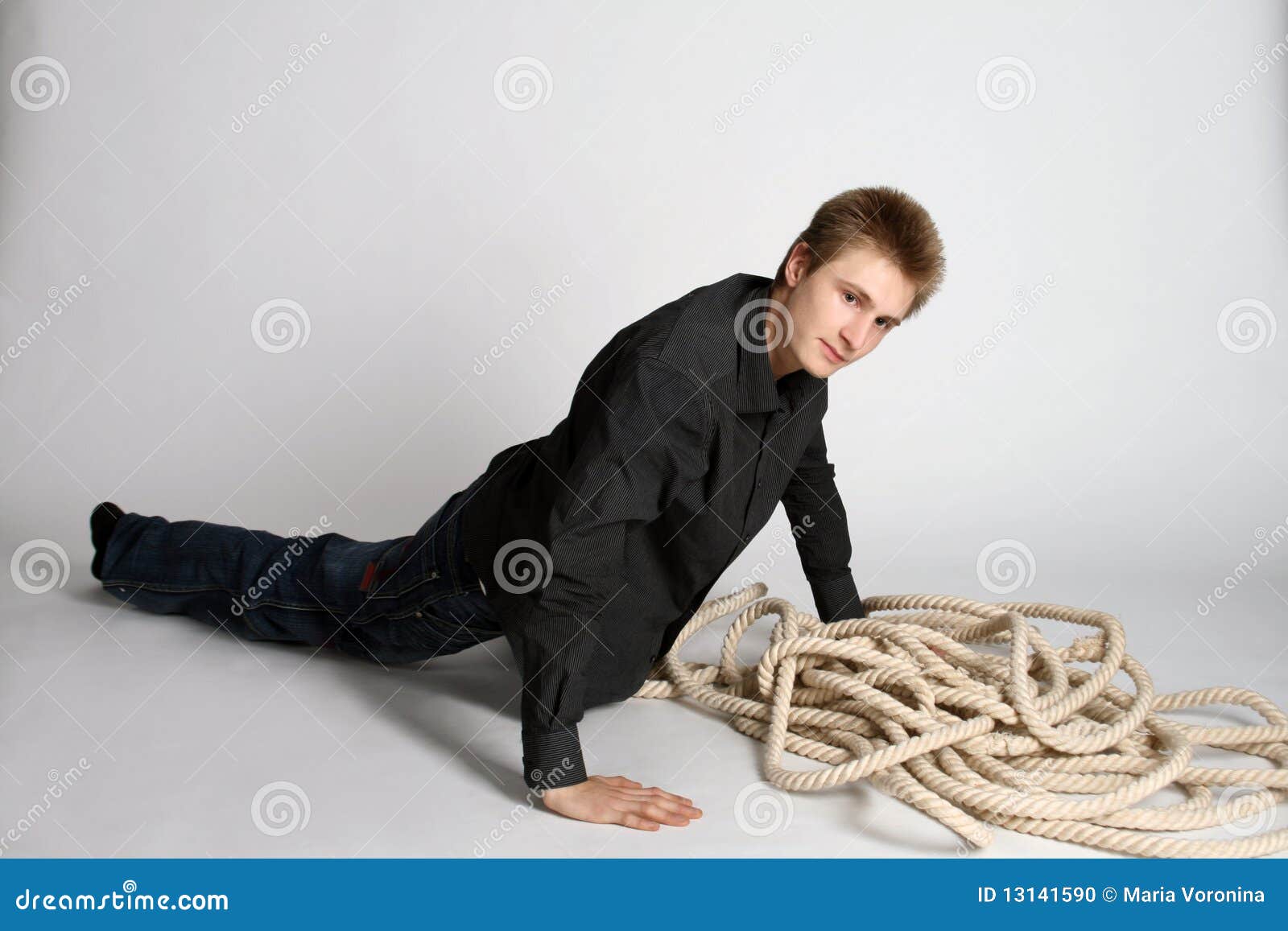 Handsome man lying on rope stock photo. Image of rising - 13141590