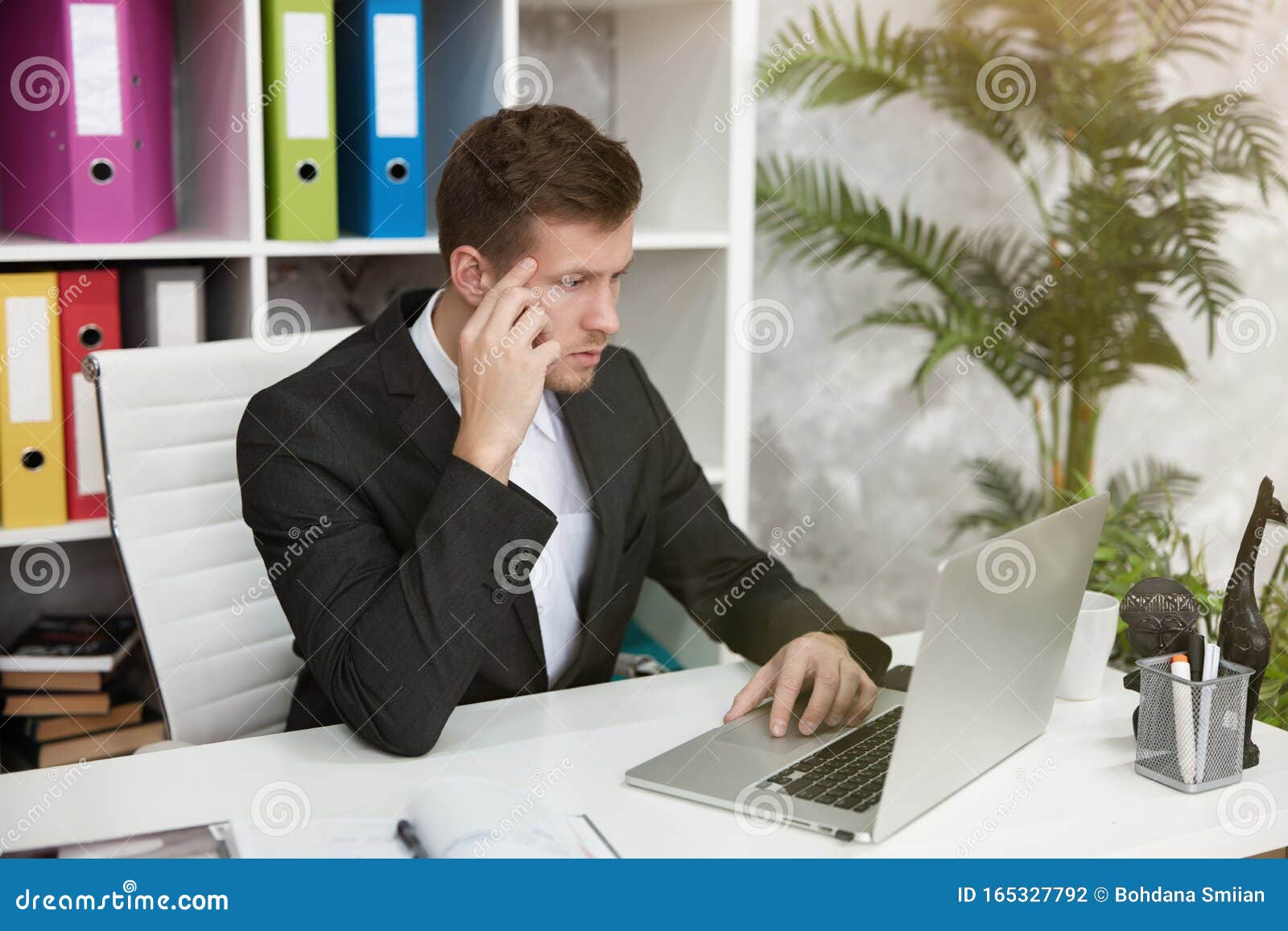 Handsome Man Manager Looks Puzzled Sitting at His Working Place in ...