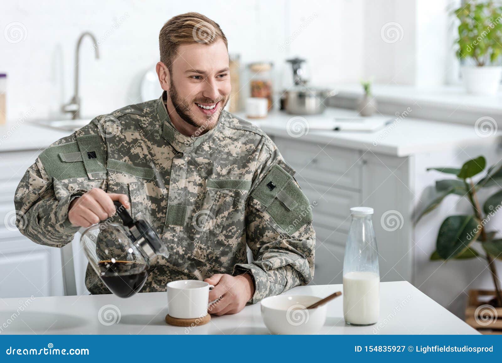 Handsome Man in Military Uniform Smiling and Pouring Coffee in Cup from ...
