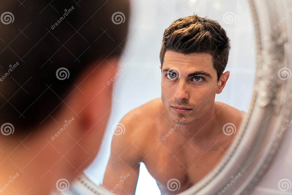 Handsome man in mirror stock image. Image of skin, adult - 64778859