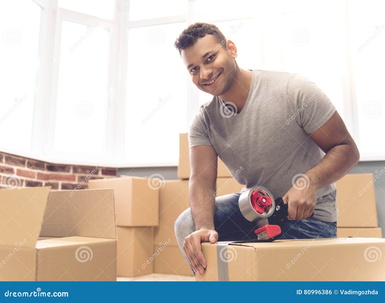 Handsome man moving stock photo. Image of adhesive, male - 80996386