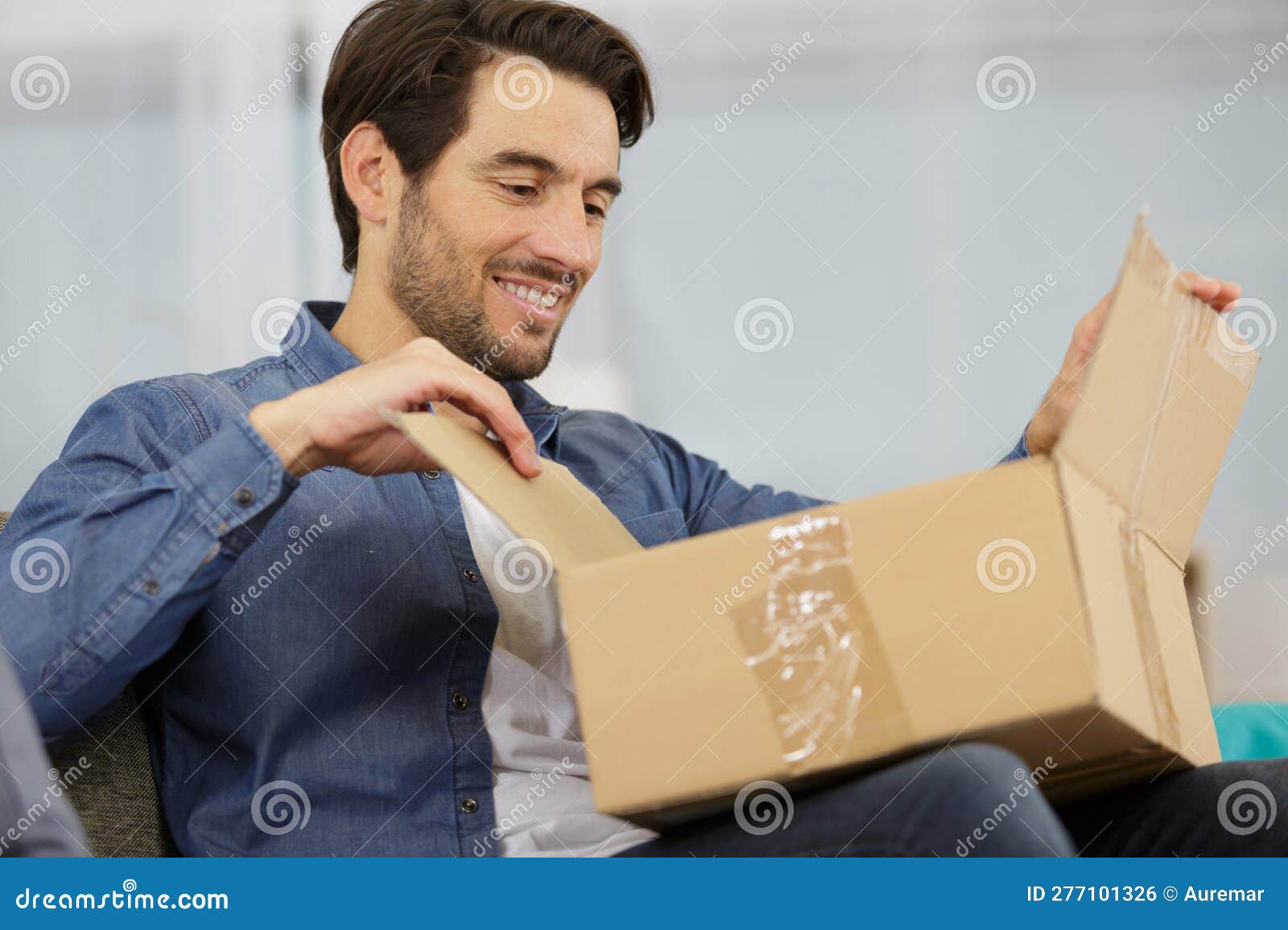 Handsome Man Opening Parcel at Home Stock Photo - Image of flat ...