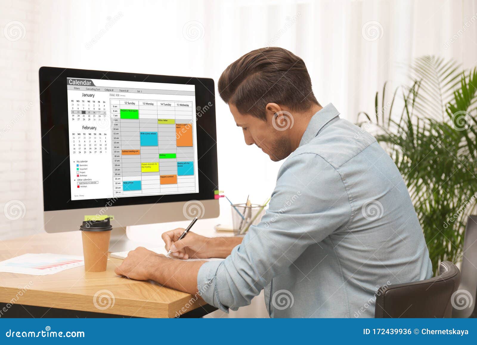 Handsome Man Planning His Schedule with Calendar App on Computer Stock ...