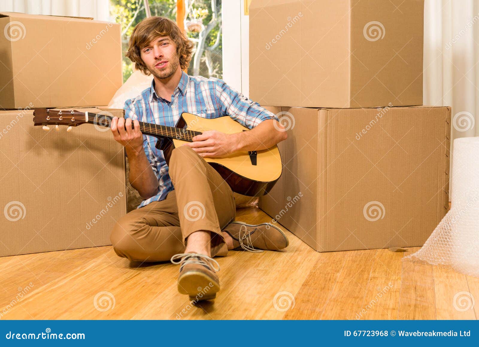 Handsome Man Playing Guitar with Moving Boxes Stock Photo - Image of ...